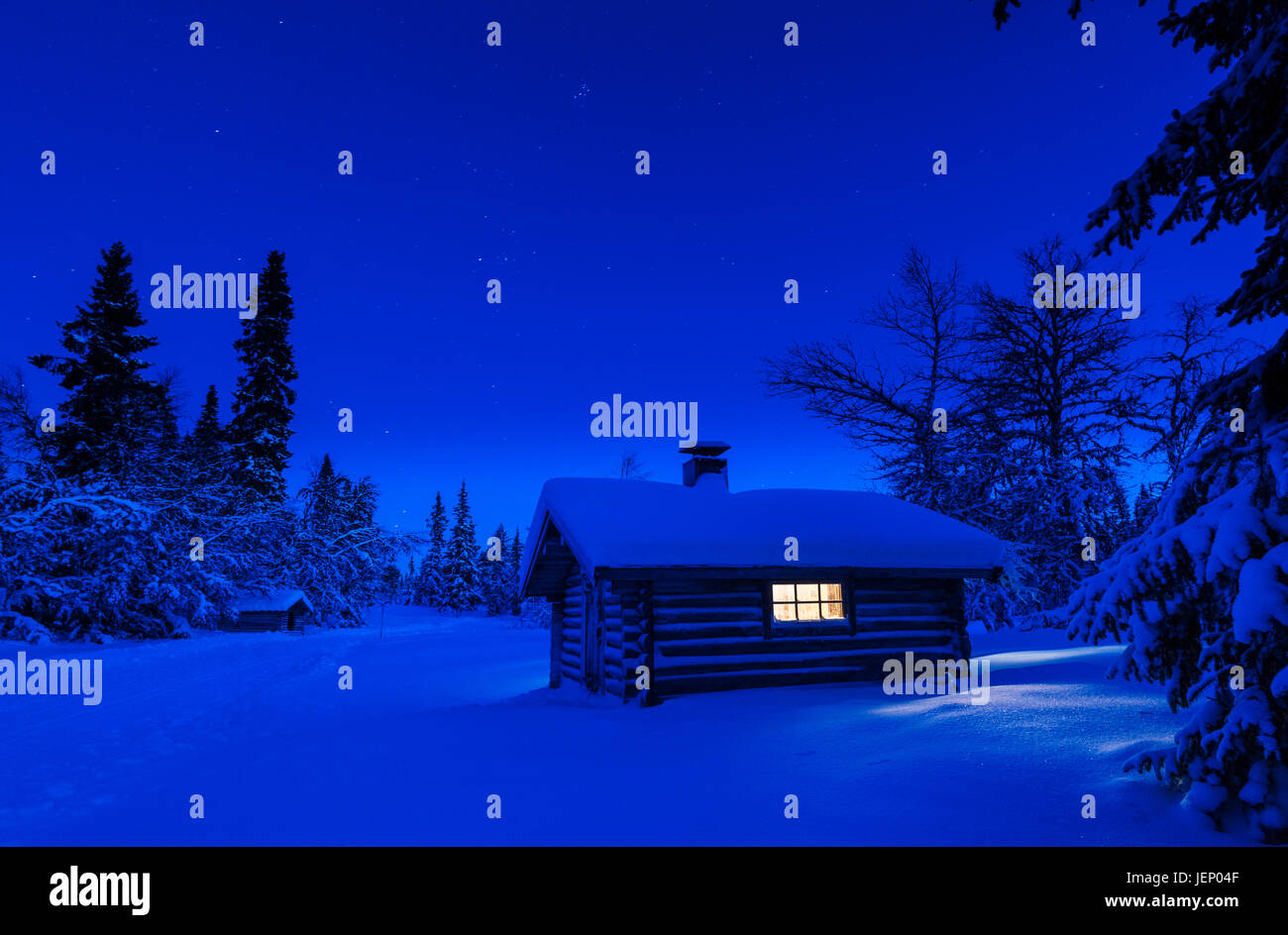 Illuminated log house at night Stock Photo - Alamy