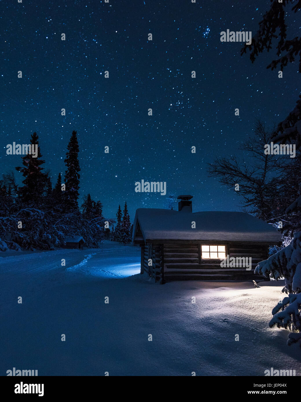 Illuminated log house at night Stock Photo - Alamy