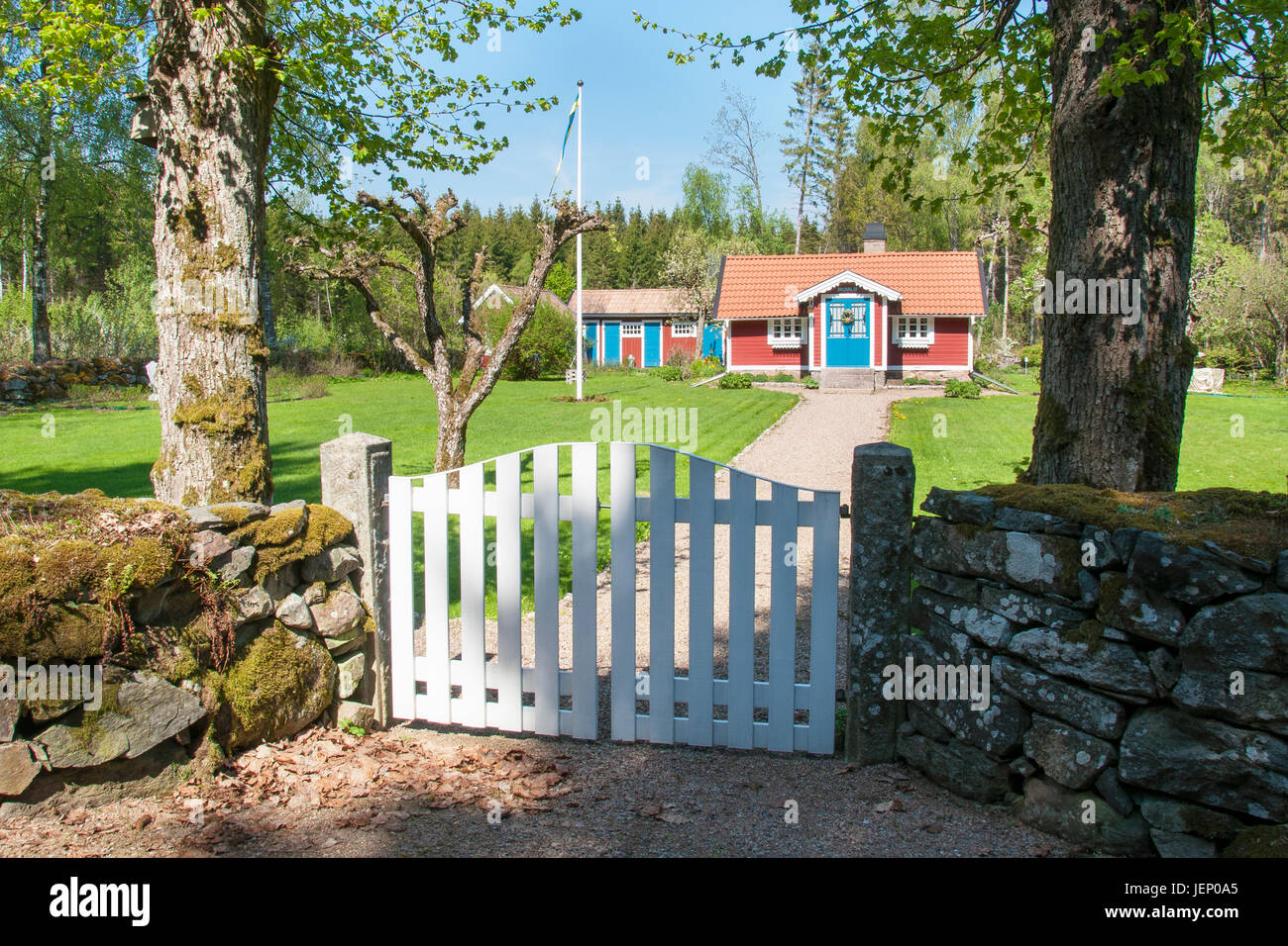 Wooden house with gate on foreground Stock Photo - Alamy