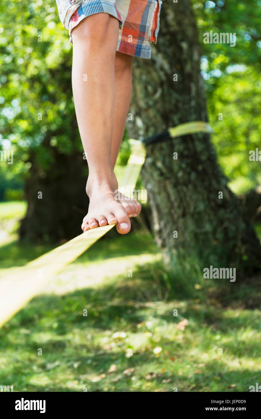 Person walking on slack line Stock Photo - Alamy