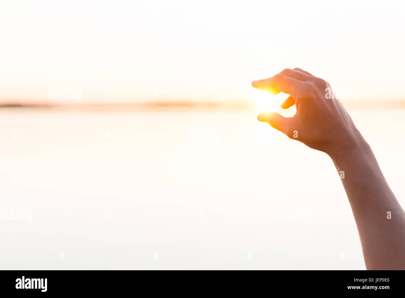 Hand holding sun Stock Photo - Alamy