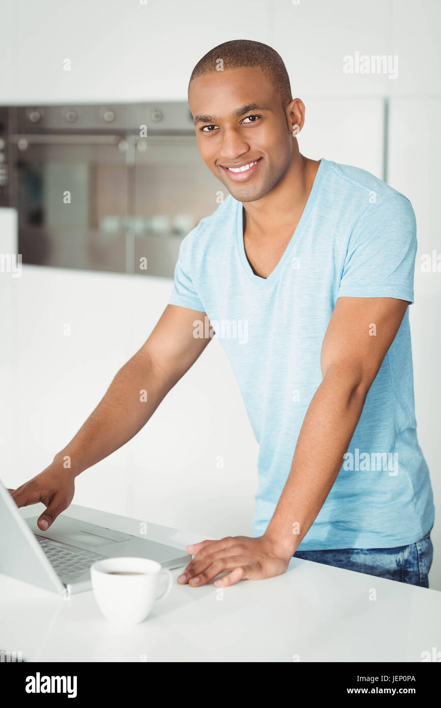 Handsome man using laptop Stock Photo - Alamy