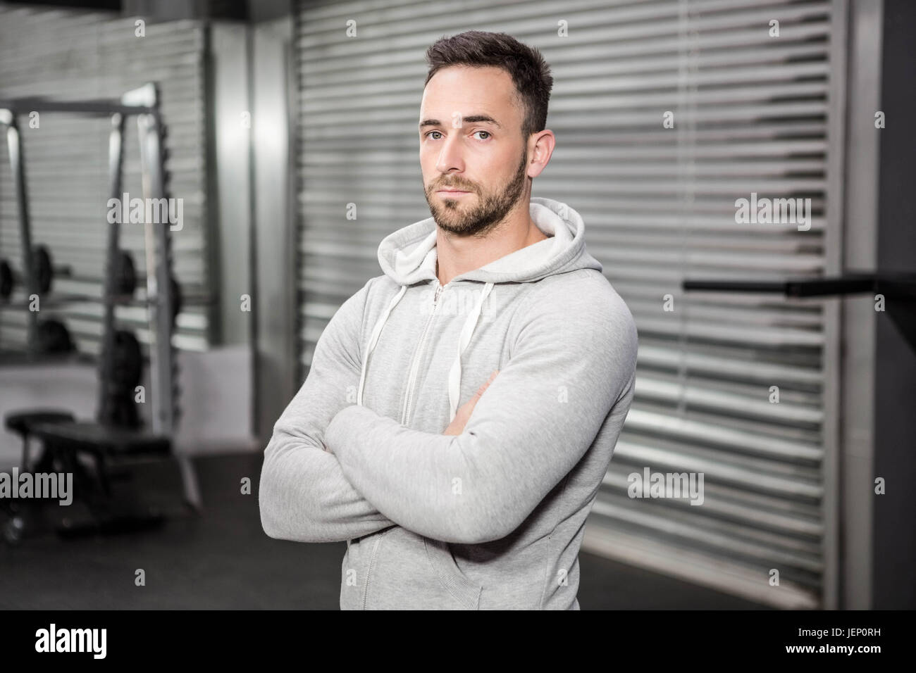 Confident man standing with arms crossed Stock Photo - Alamy
