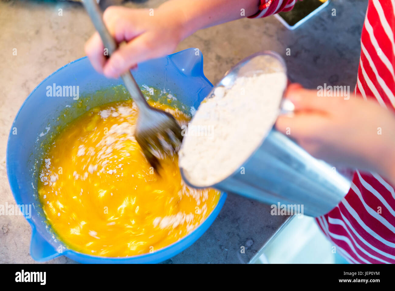 Close-up of child mixing food Stock Photo - Alamy