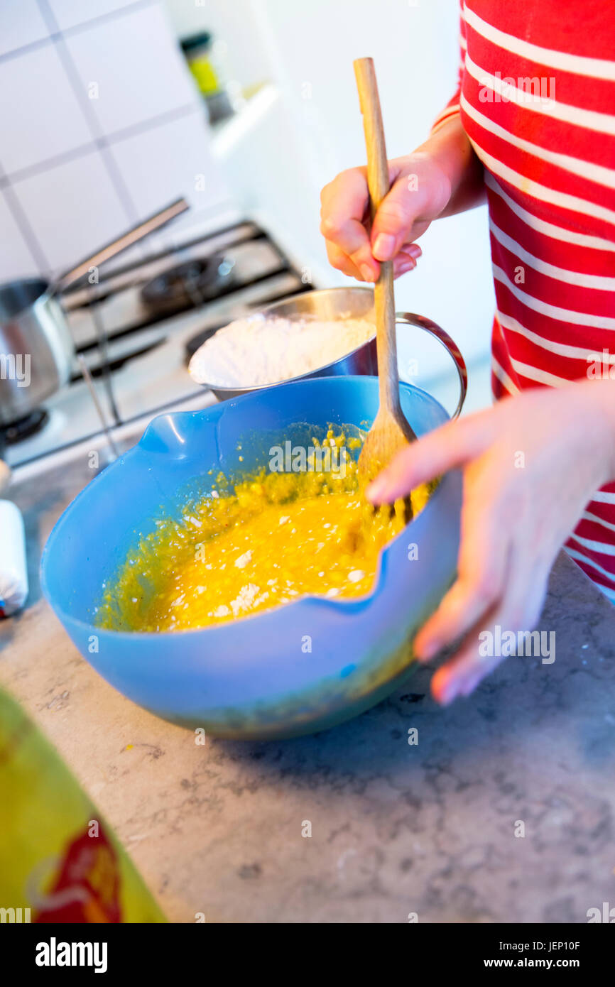 Close-up of child mixing food Stock Photo - Alamy