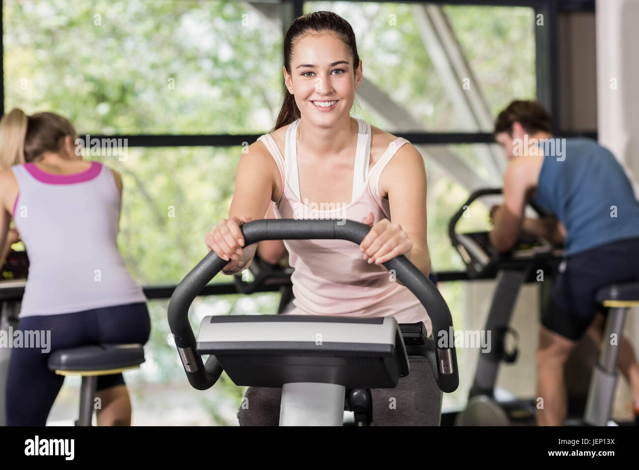 Fit woman doing exercise bike Stock Photo - Alamy