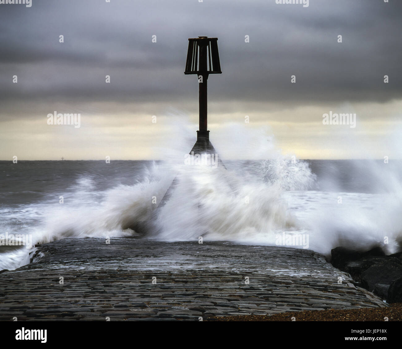 Waves from the sea crashing around a seaside jetty during storm Angus ...