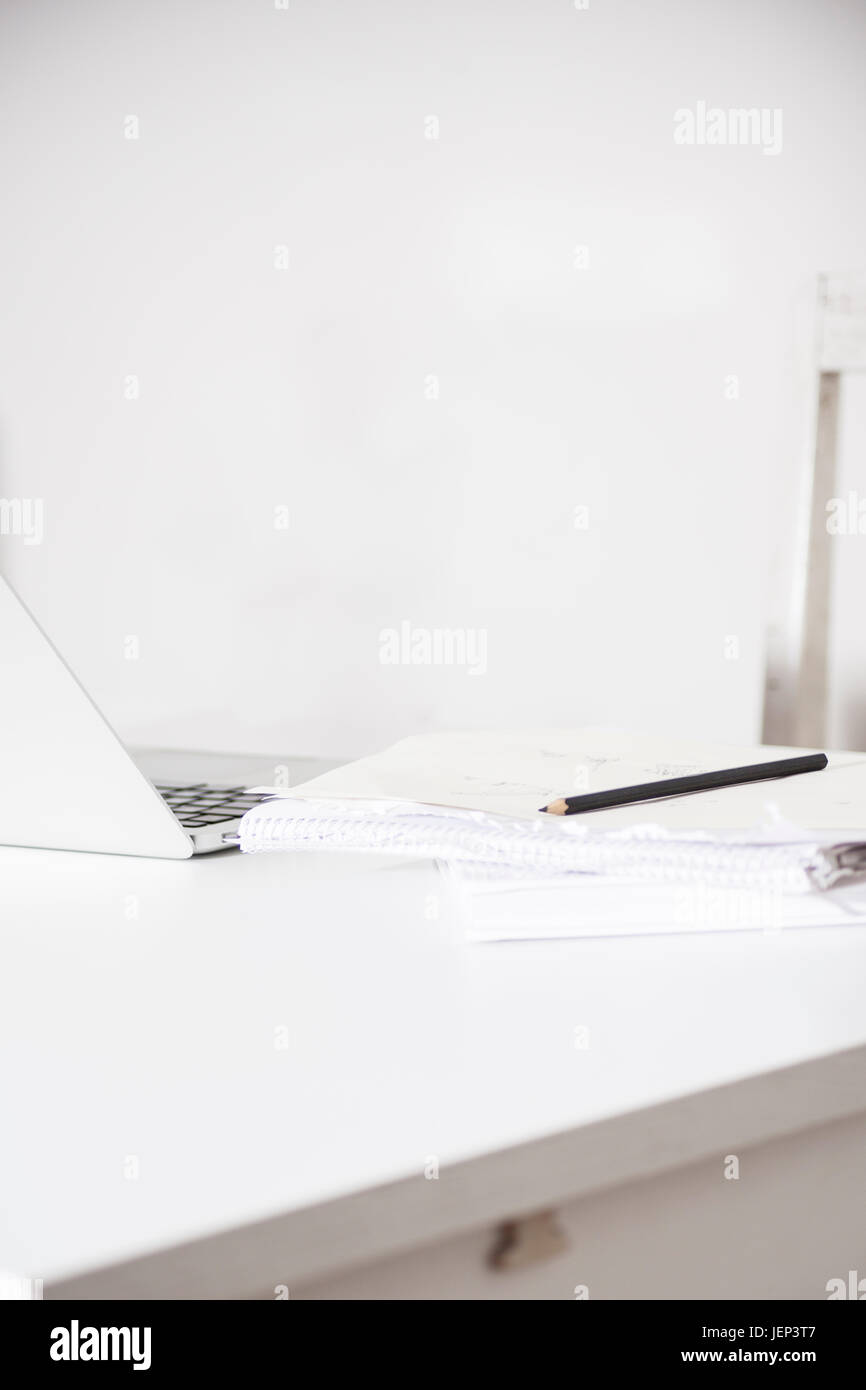 Desk with notebook and laptop Stock Photo - Alamy