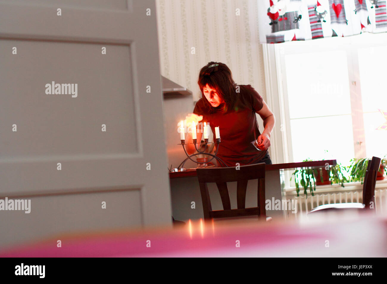 Woman lighting candles Stock Photo - Alamy