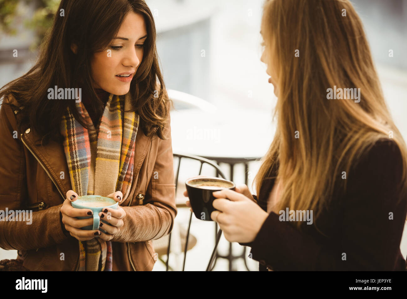 Friends chatting over coffee Stock Photo - Alamy