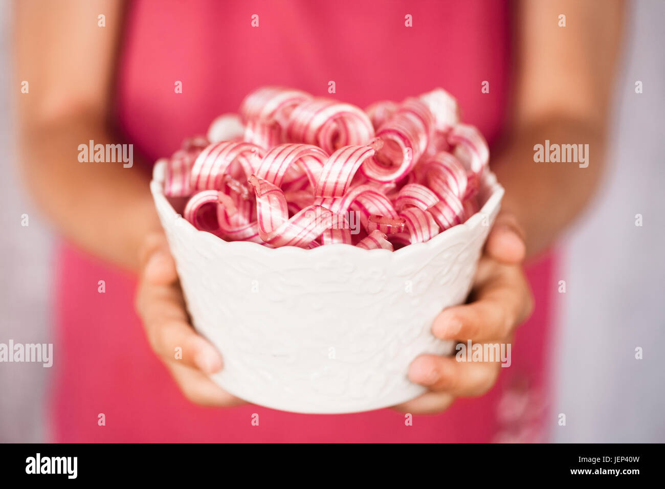 Bowl with curly sweets Stock Photo - Alamy