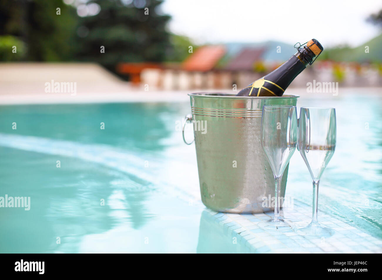 Ice bucket champagne bottle and two glasses near smimming pool Stock ...