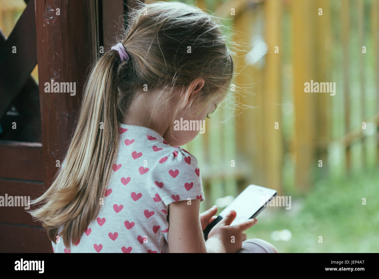 Little girl using digital technology, modern lifestyle for young kids ...