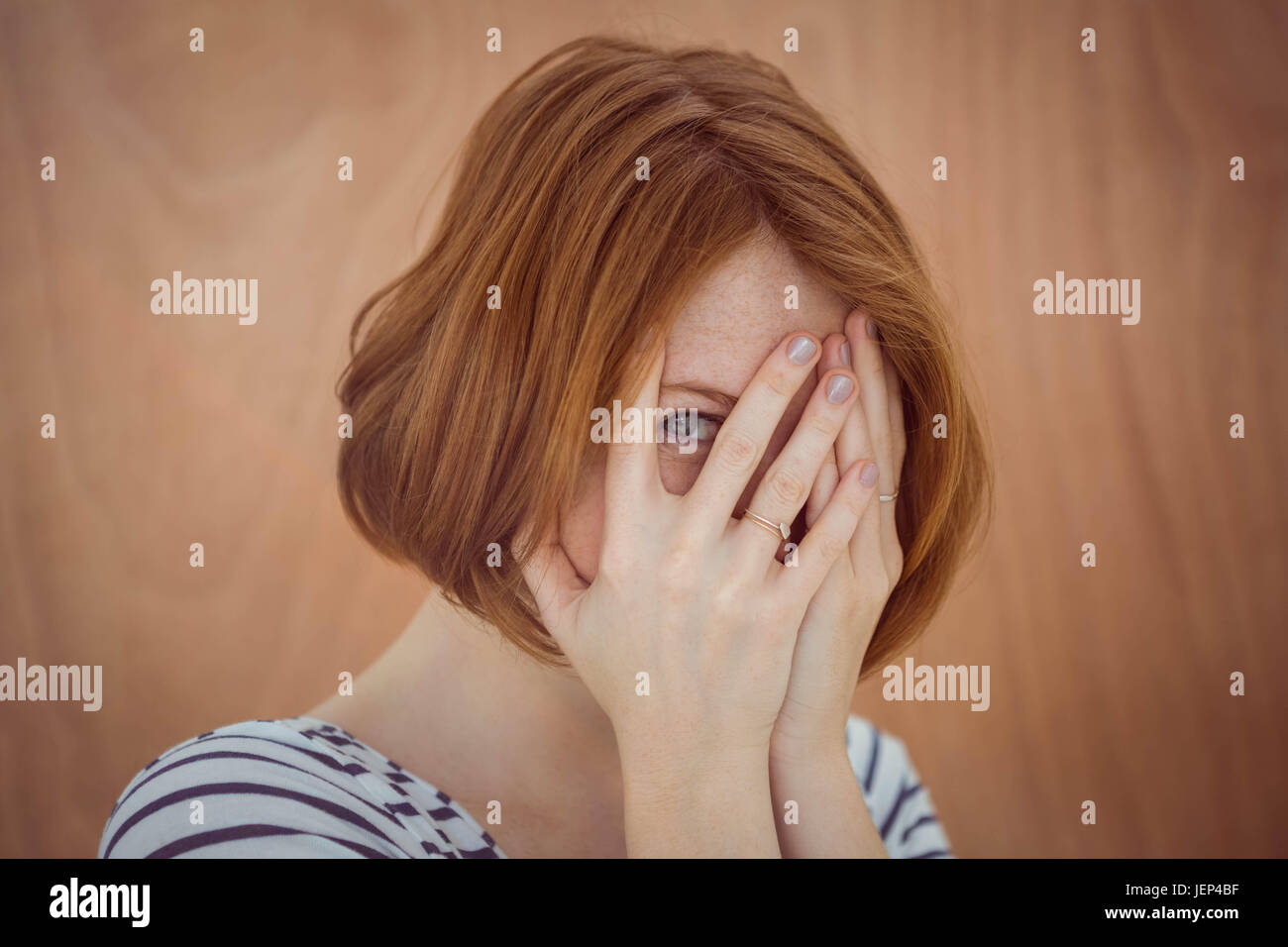 Shy embarrassed young female hiding hi-res stock photography and images ...