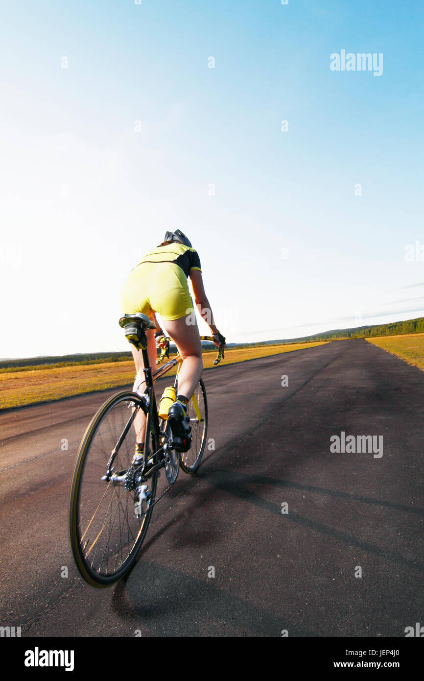 Woman cycling, rear view Stock Photo - Alamy