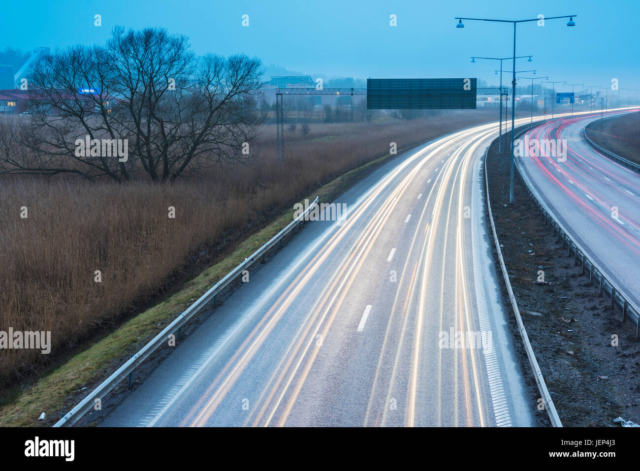 Car lights on road at dusk Stock Photo - Alamy