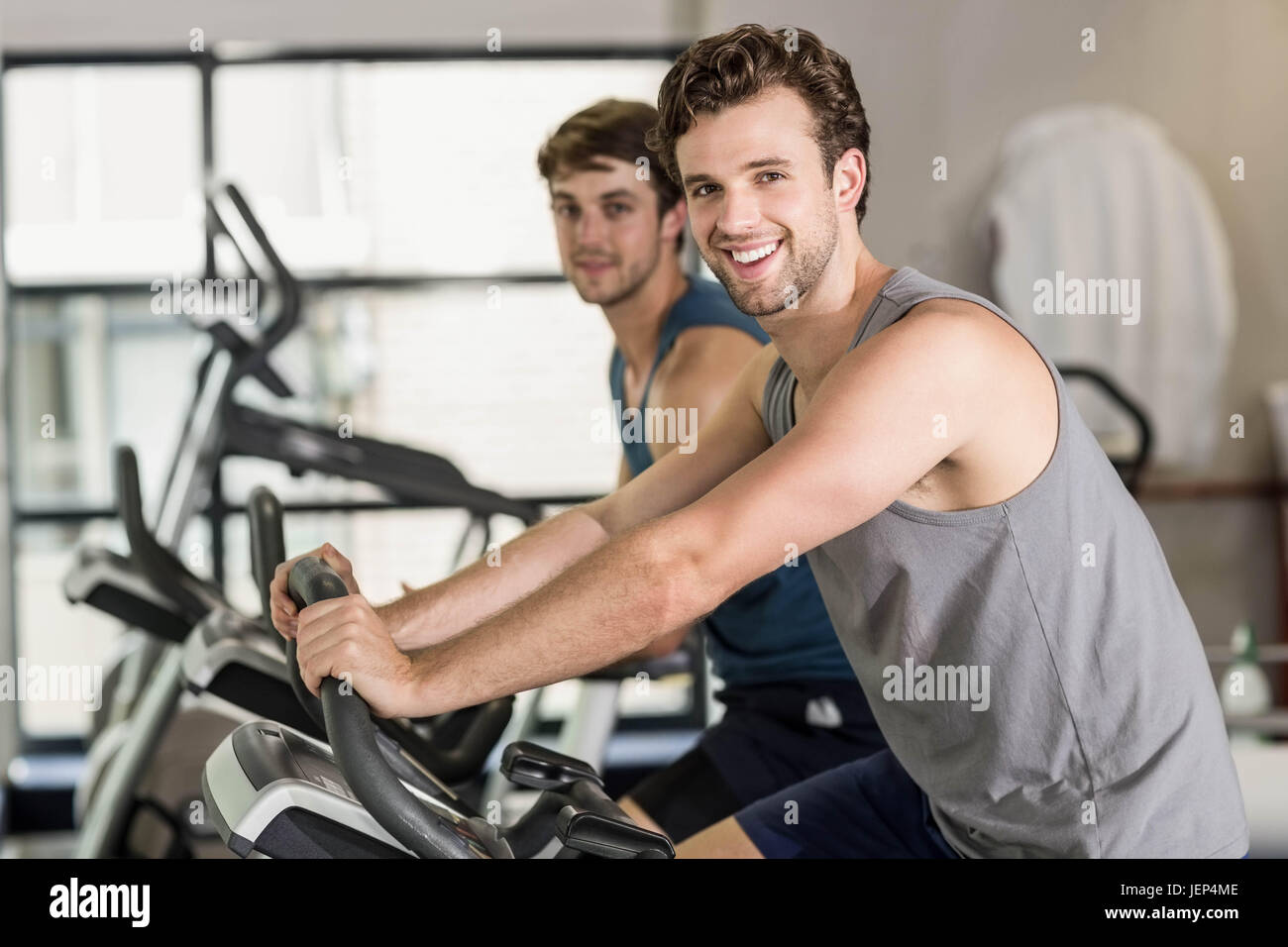 Fit people doing exercise bike Stock Photo - Alamy