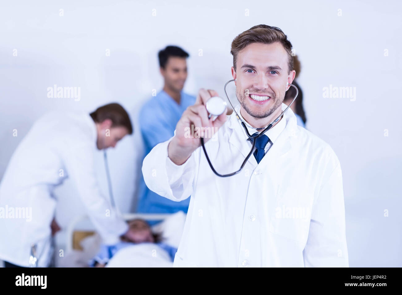 Doctor showing stethoscope towards camera Stock Photo - Alamy