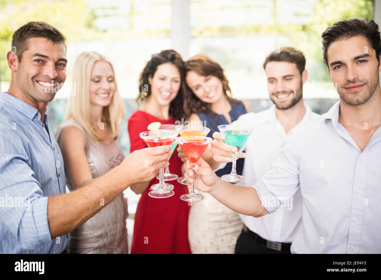 Group of friends having cocktail Stock Photo - Alamy