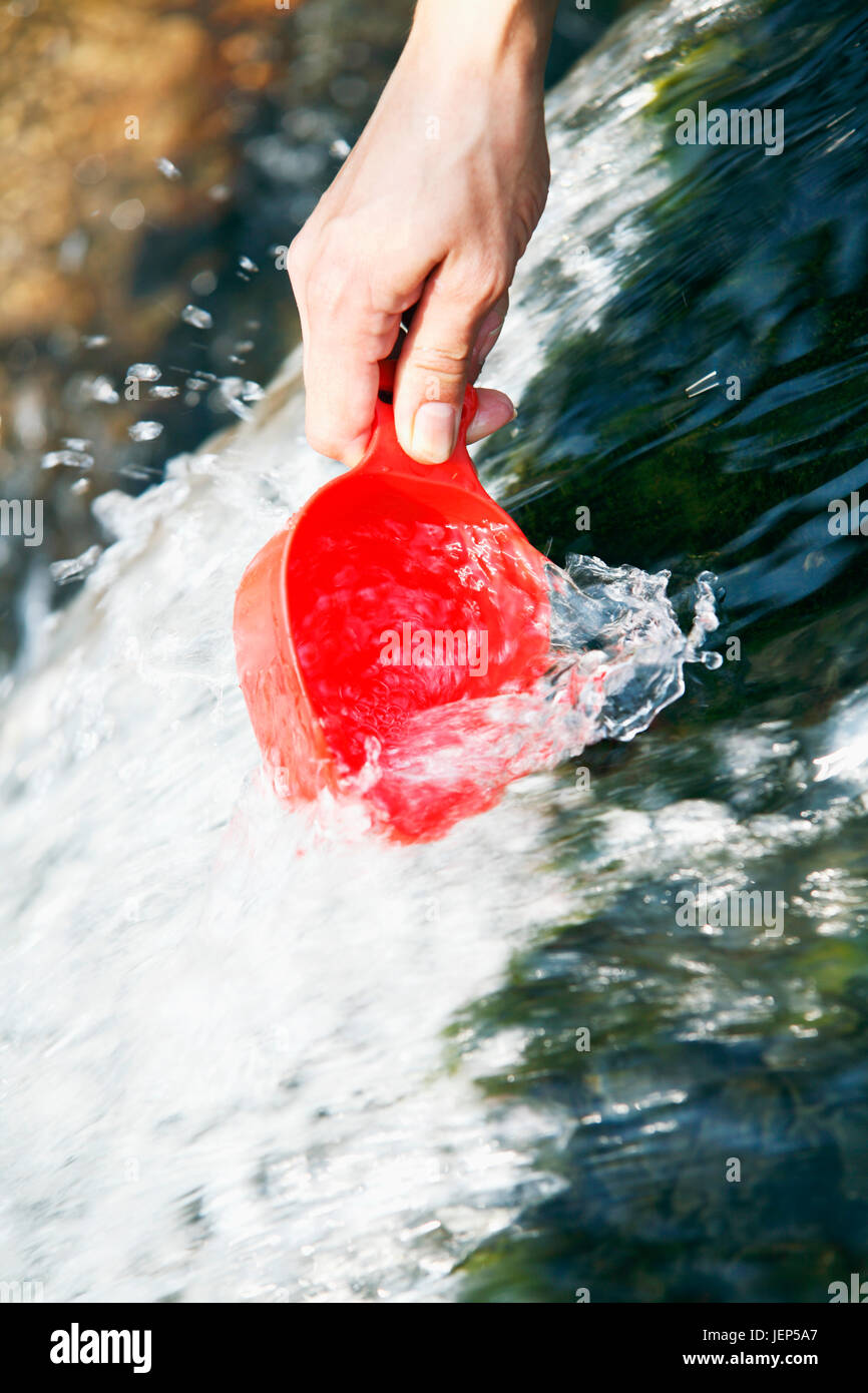 Hand taking water from river Stock Photo - Alamy