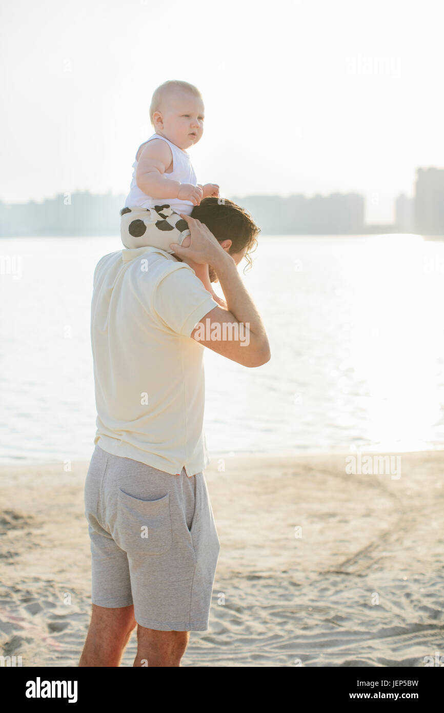 father carrying baby on shoulders at beach Stock Photo - Alamy