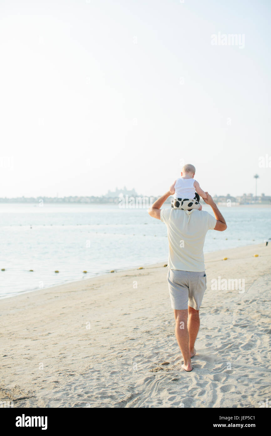 father carrying baby on shoulders at beach Stock Photo - Alamy