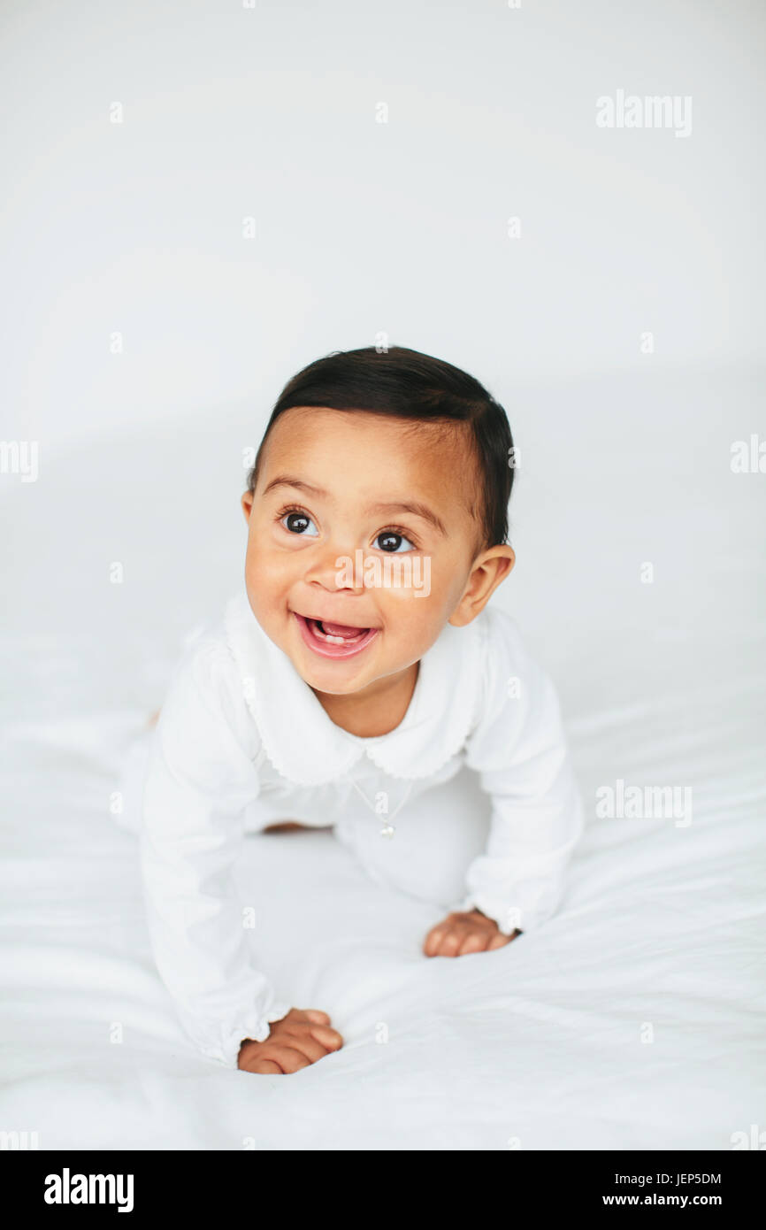 Smiling baby crawling Stock Photo - Alamy