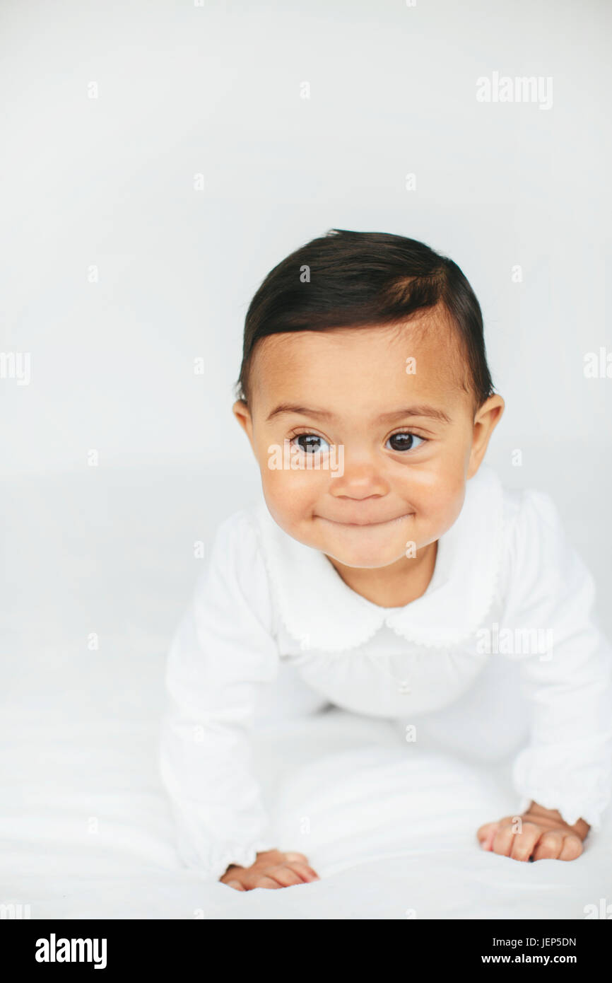 Smiling baby crawling Stock Photo - Alamy