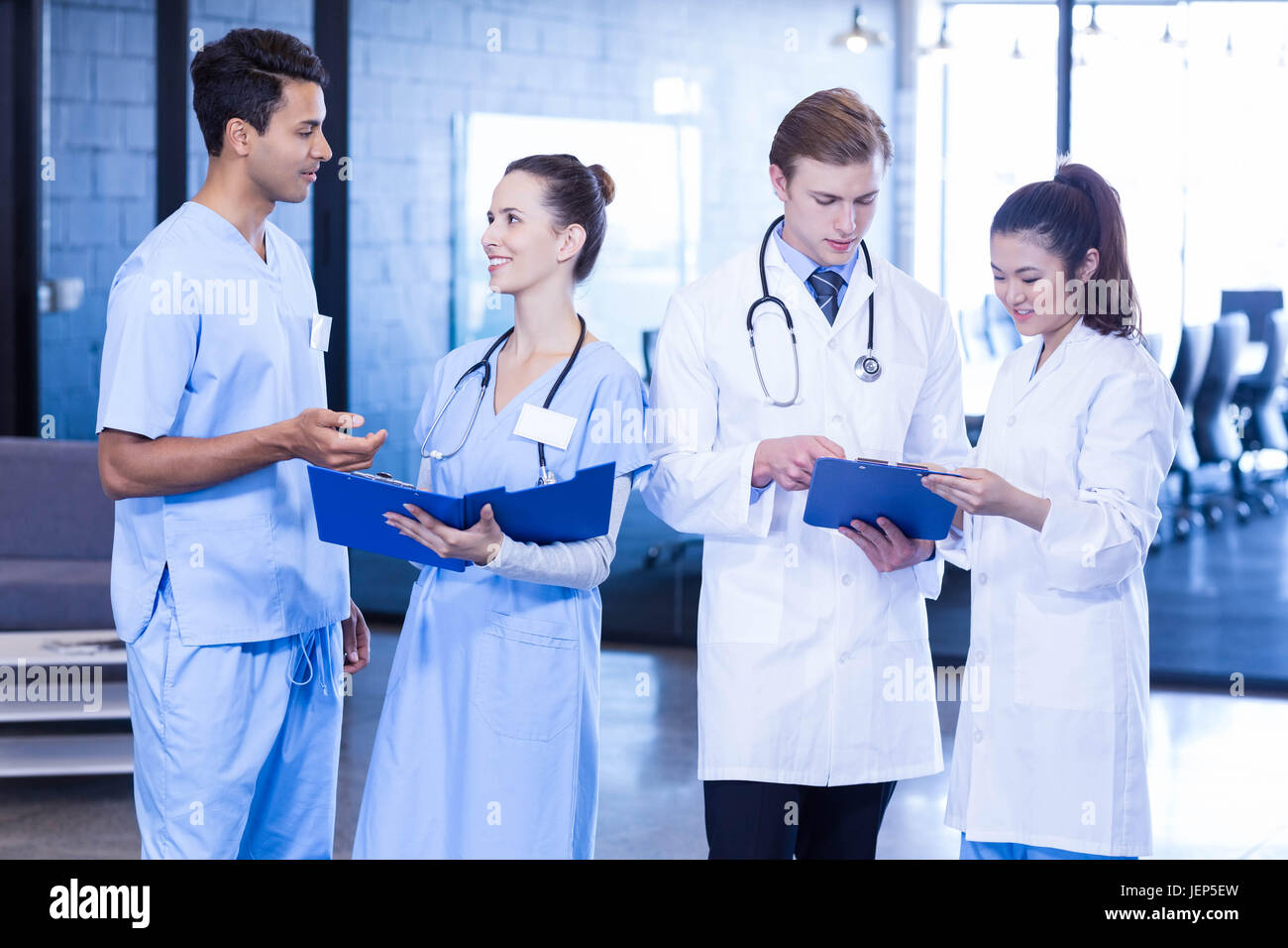Doctors looking at medical report Stock Photo - Alamy