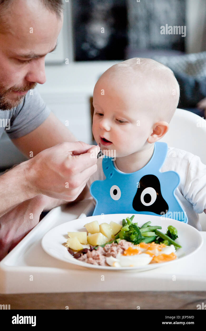 Father feeding baby boy Stock Photo - Alamy