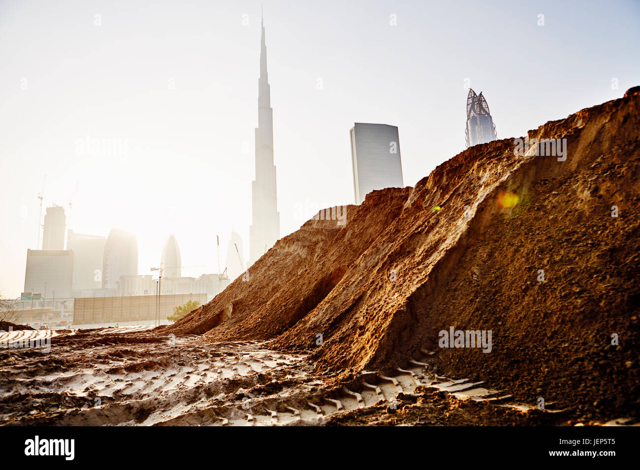 Pile of dirt at building site, Dubai skyscraper on background Stock ...