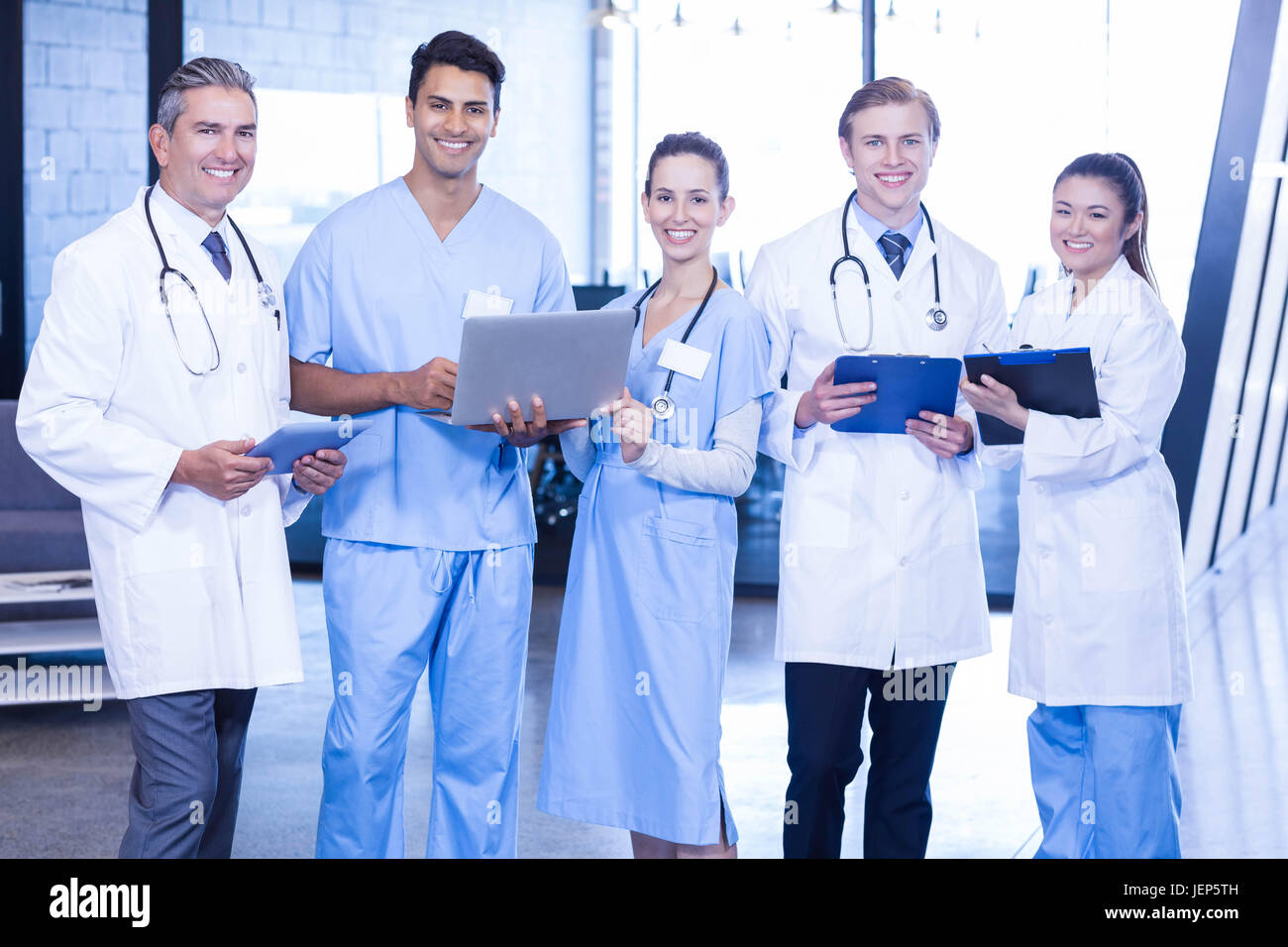 Doctors looking at camera and smiling Stock Photo - Alamy