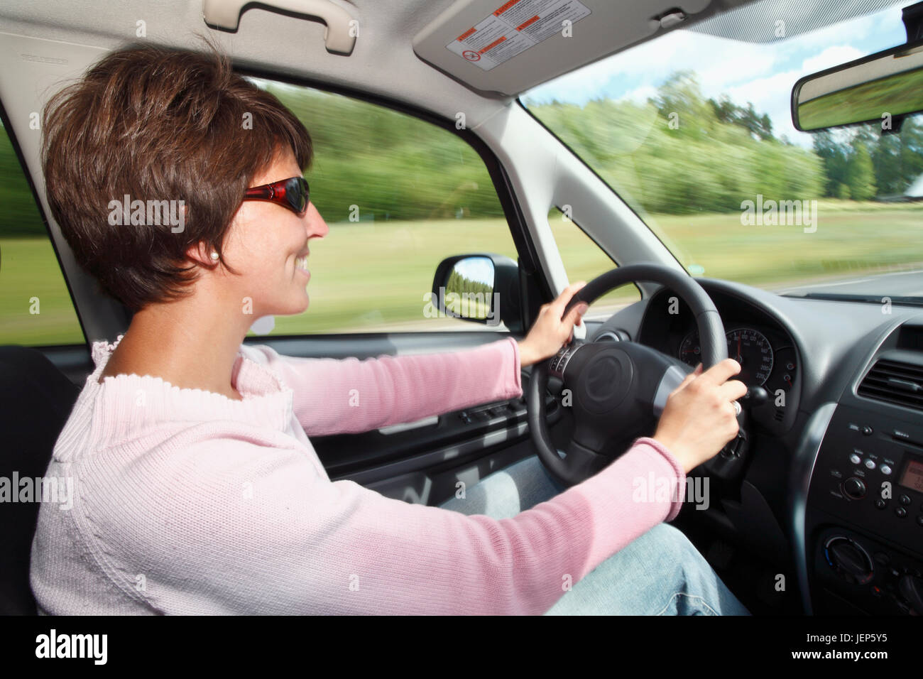 Smiling woman driving Stock Photo - Alamy