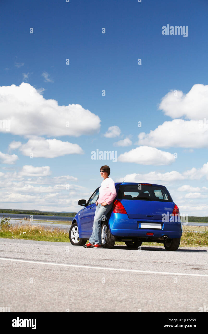 Woman standing near car at country road Stock Photo - Alamy