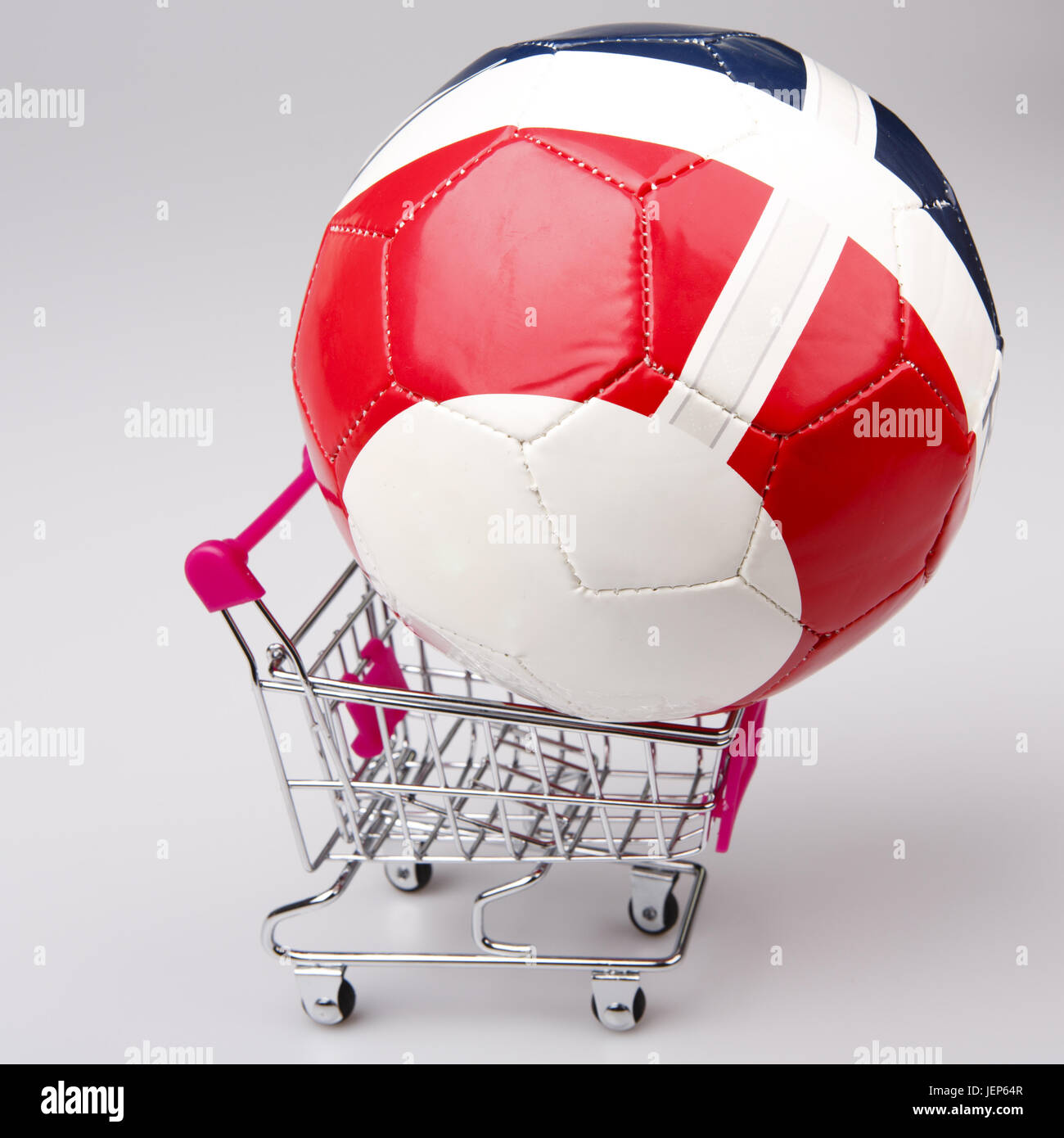 football ball in ping shopping cart on white background Stock Photo - Alamy