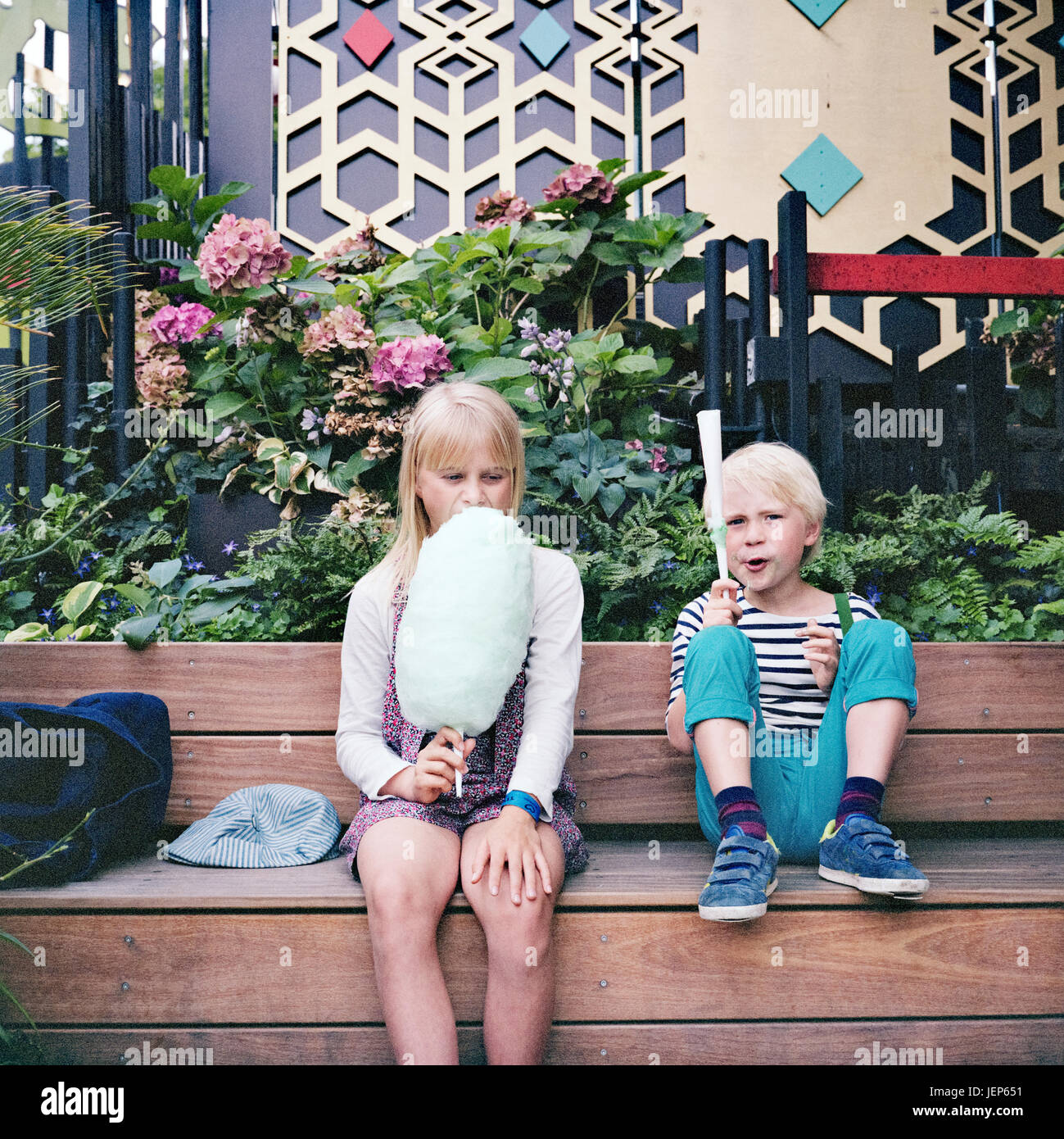 Children on bench having candy floss Stock Photo - Alamy