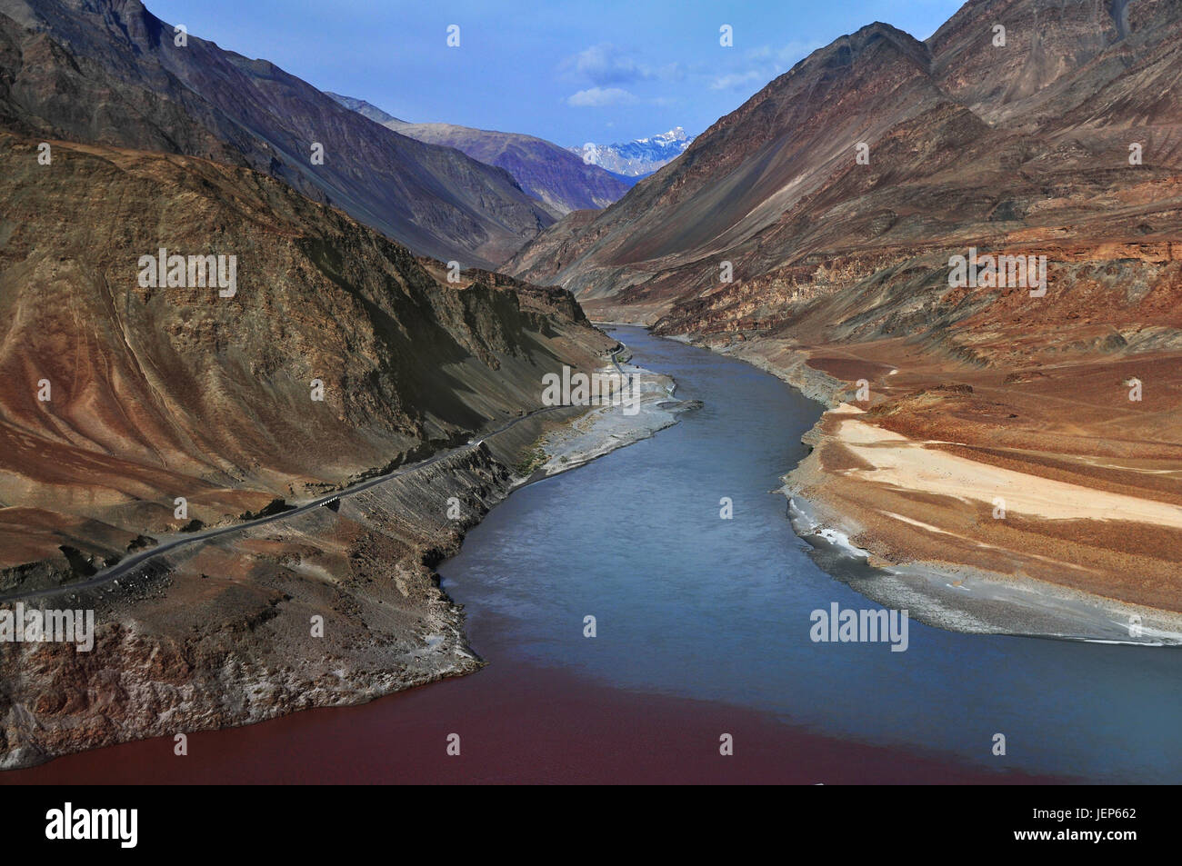 The confluence of the two mountain rivers: the Zanskar River blue color ...