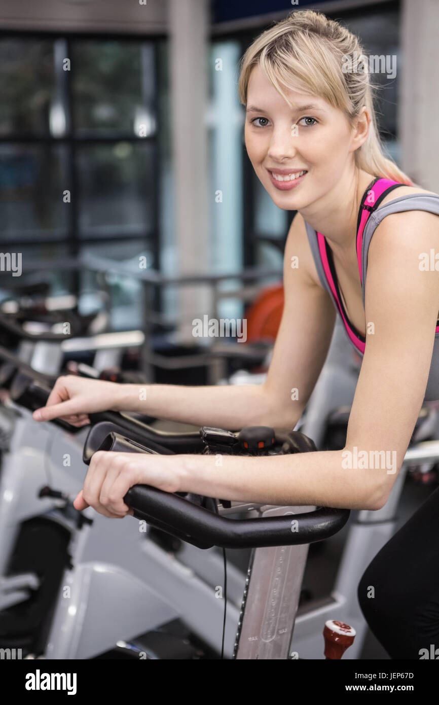 Fit woman on exercise bike Stock Photo - Alamy