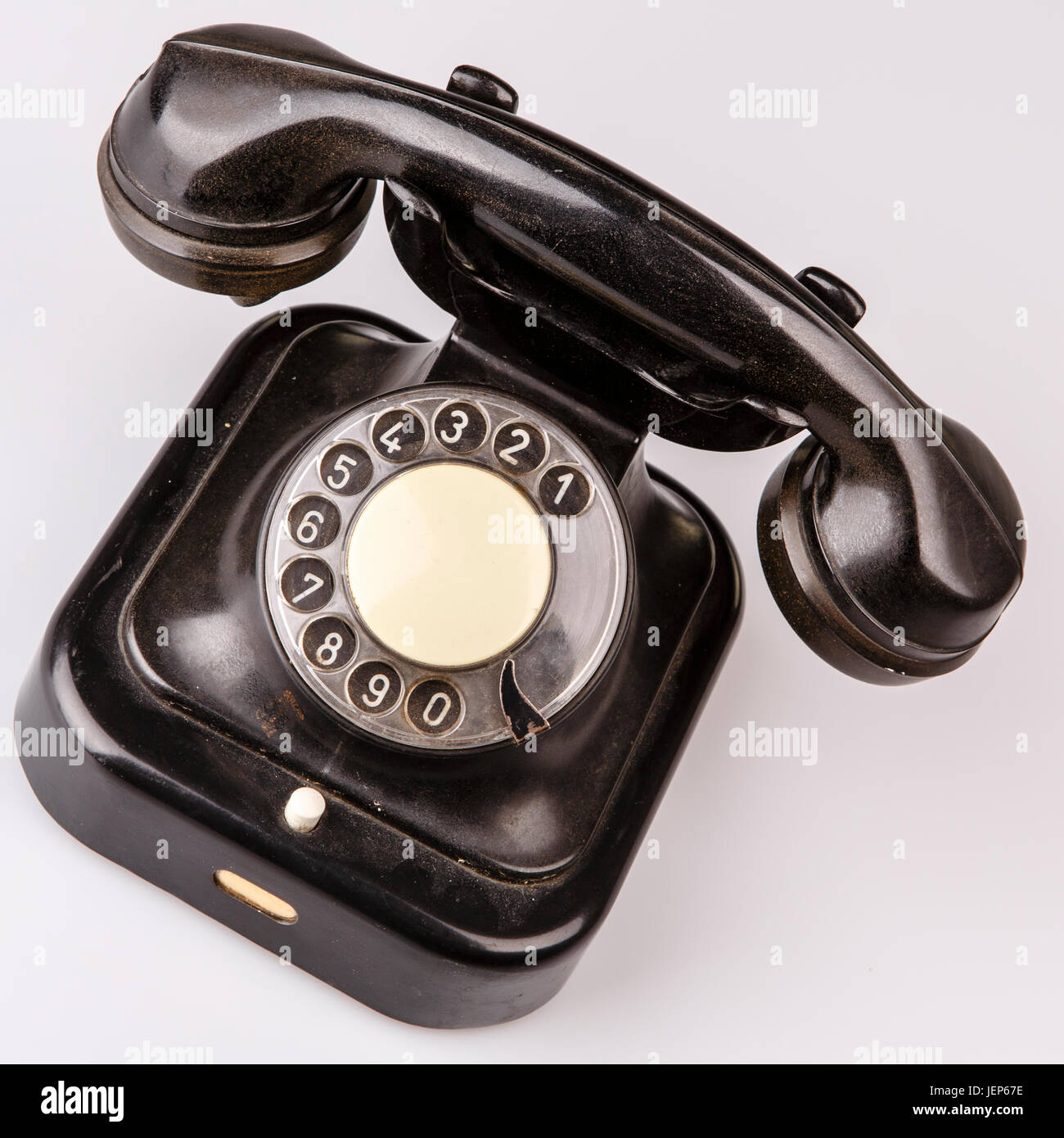 Old black phone with dust and scratches, isolated on white background ...