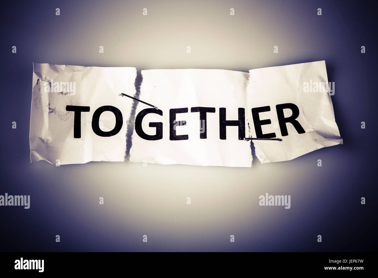 "TOGETHER" word written on torn and stapled paper on white Stock Photo ...