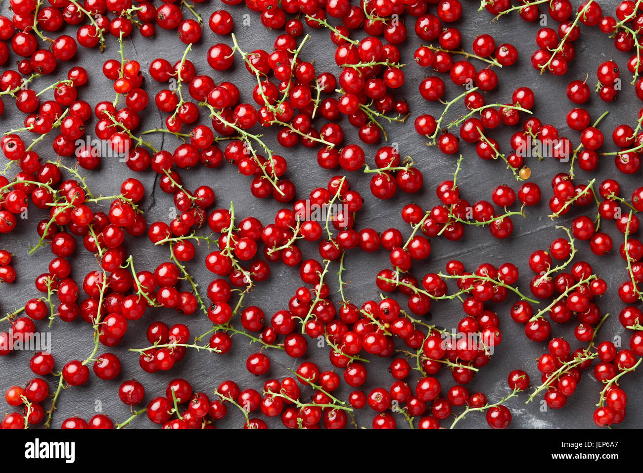 Fresh ripe red currant on gray stone background Stock Photo - Alamy