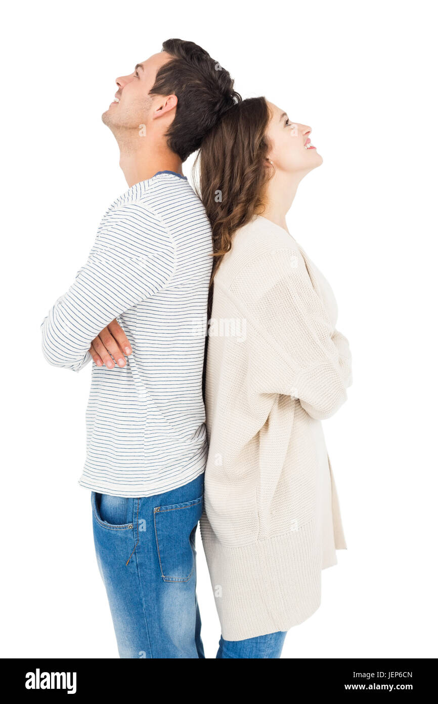 Couple standing back to back Stock Photo - Alamy