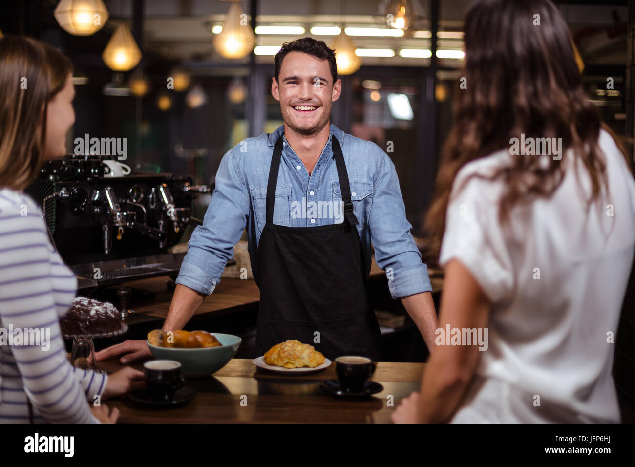 Smiling barista looking at the camera Stock Photo - Alamy