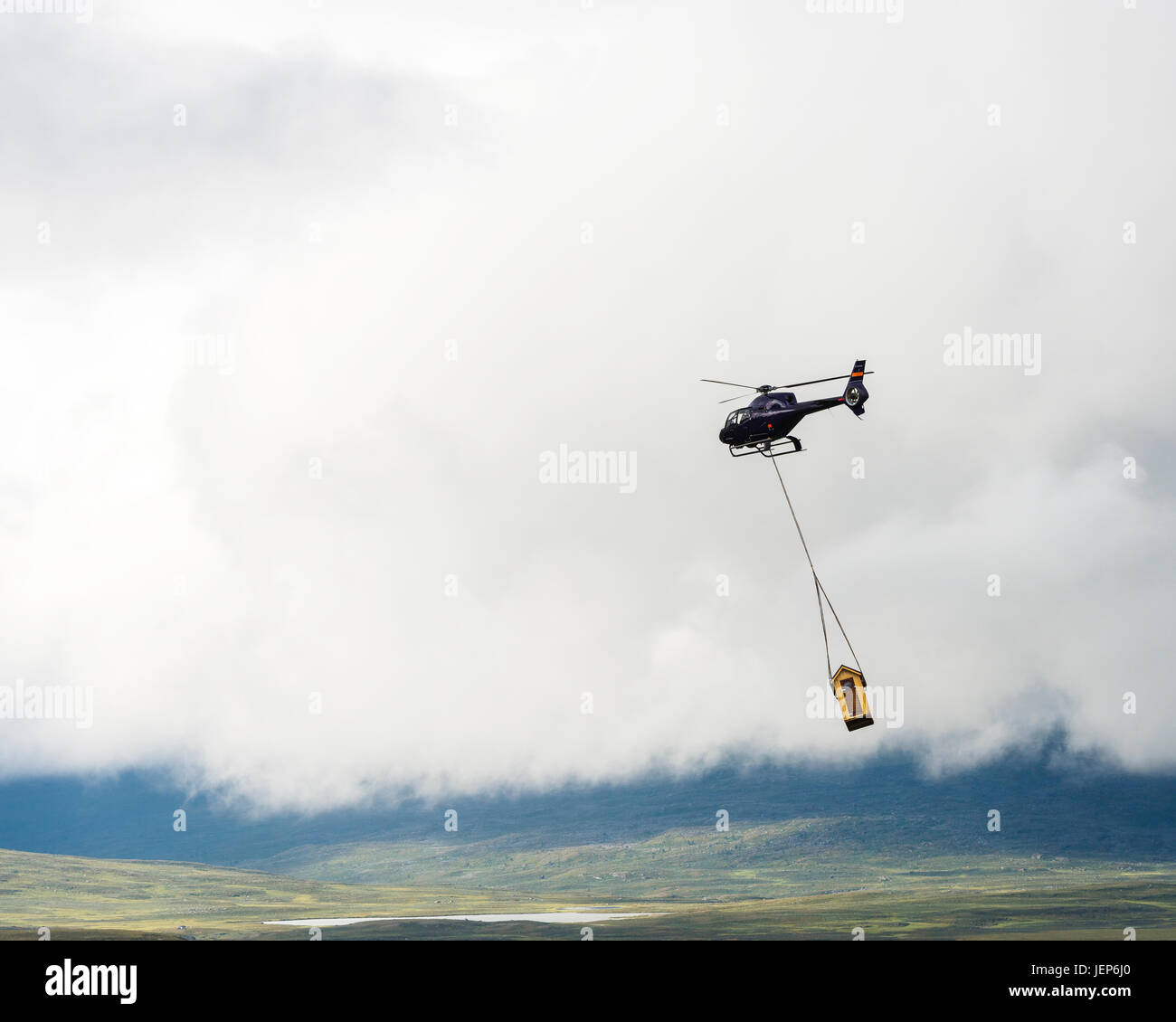 Helicopter carrying load Stock Photo - Alamy