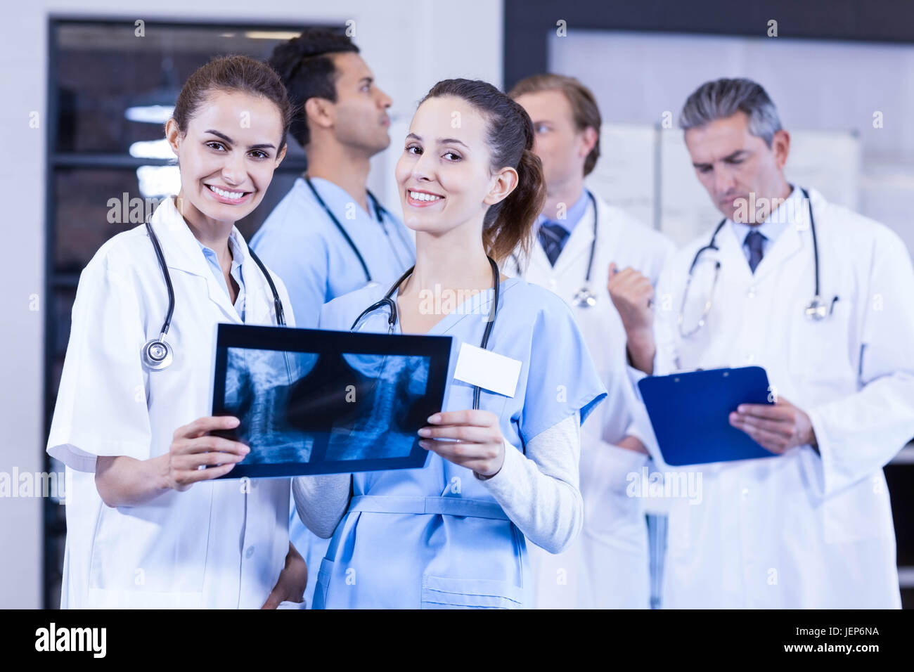 Female doctors checking x ray reports Stock Photo - Alamy