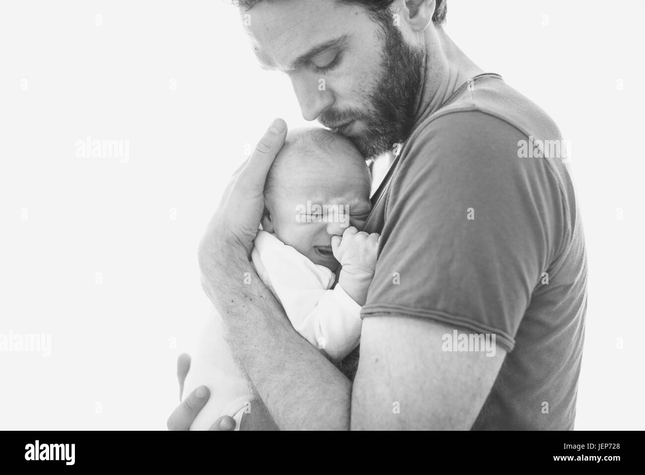 Mid adult man with newborn baby Stock Photo - Alamy