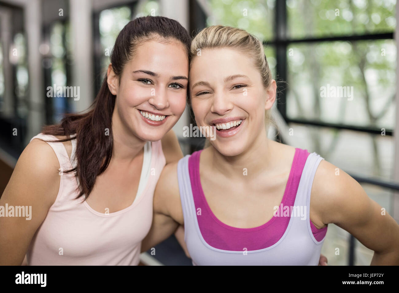Smiling friends hugging Stock Photo - Alamy