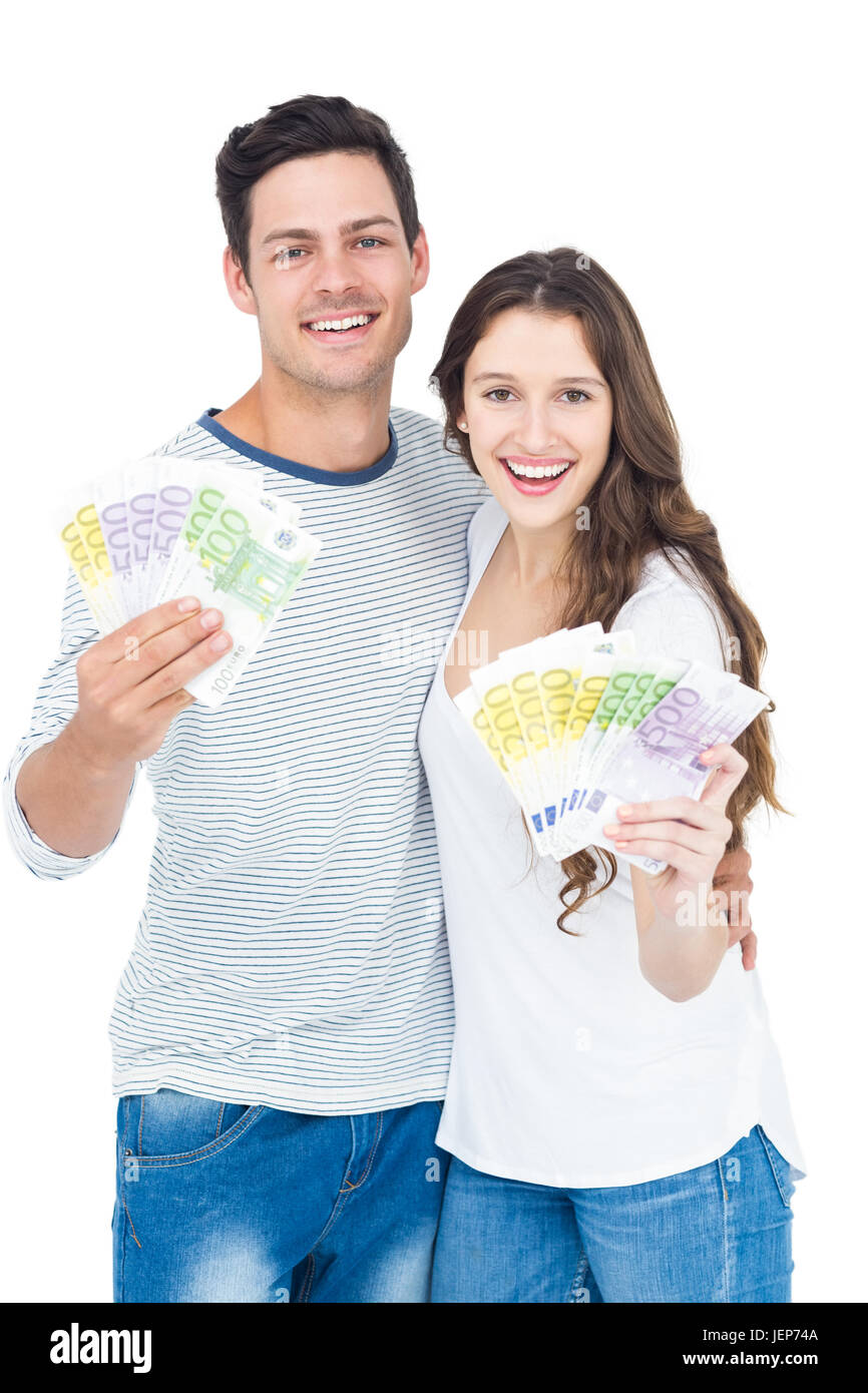Happy couple holding money Stock Photo - Alamy