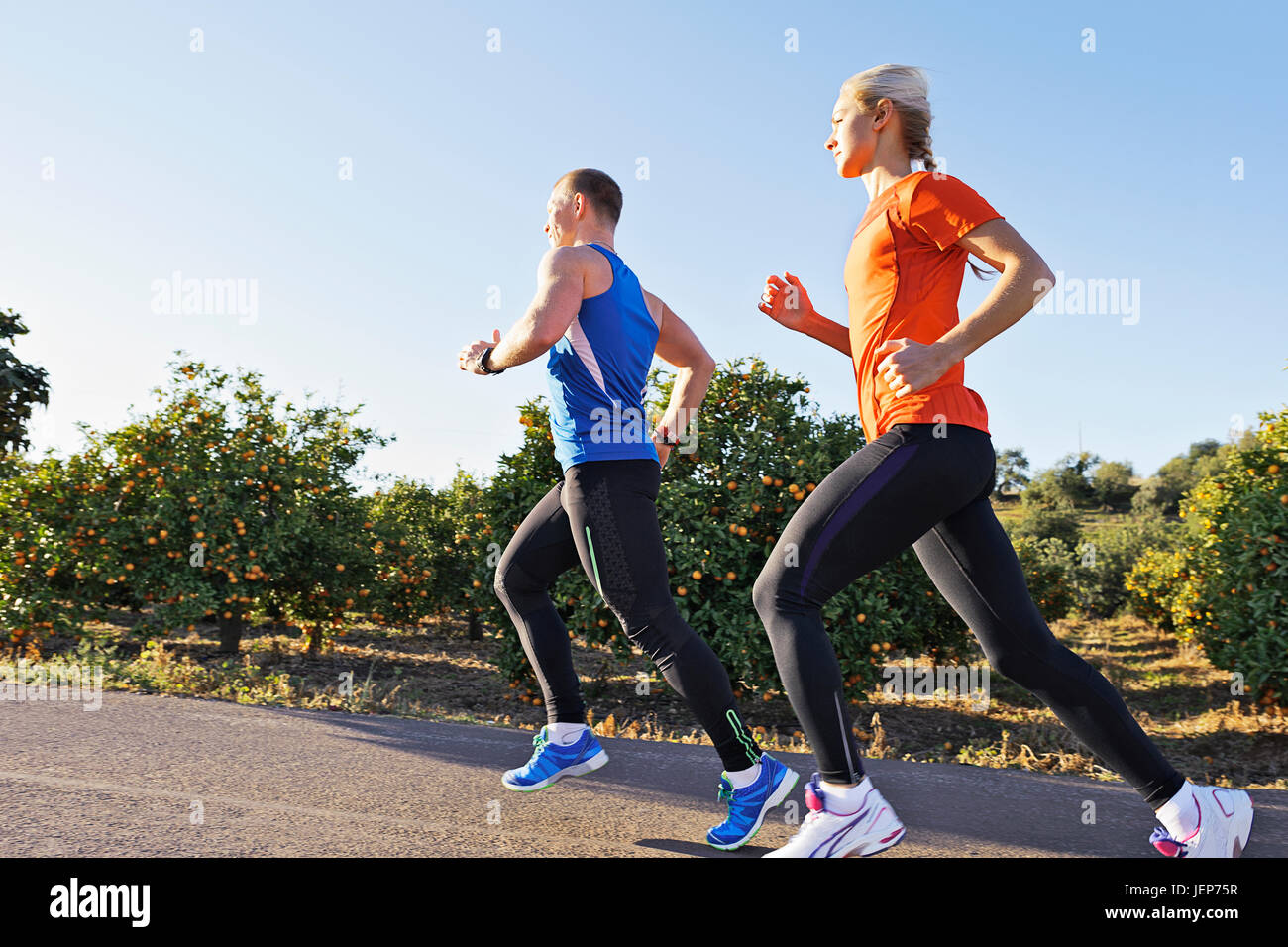 Young couple jogging Stock Photo - Alamy