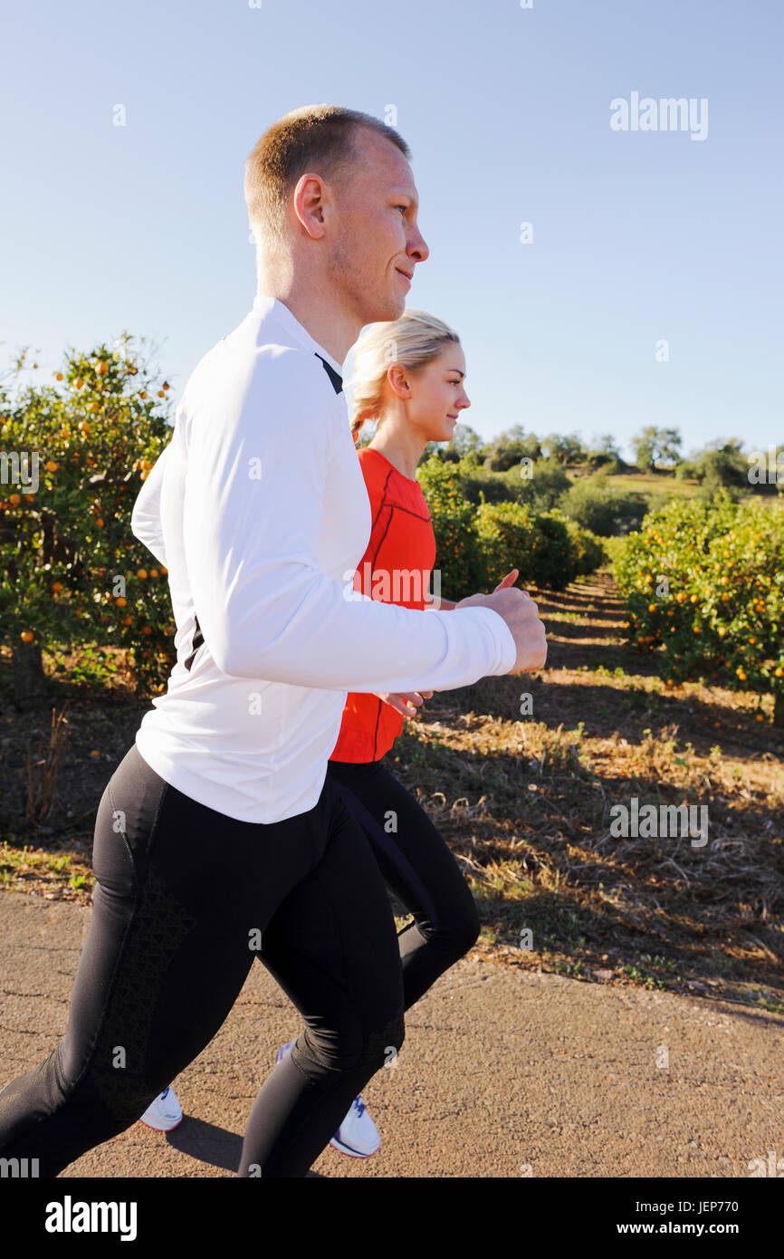 Young couple jogging Stock Photo - Alamy